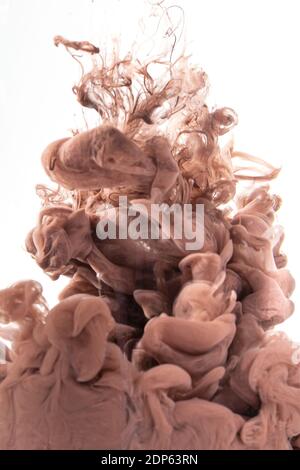 A vertical shot of chestnut brown ink in the water Stock Photo - Alamy