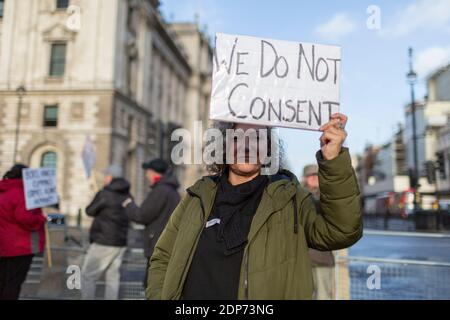 A woman is holding a placard, during the Anti Black Piet rally in ...