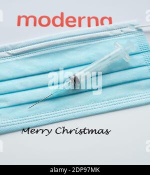 Moderna logo with a syringe and a face mask and the text merry ...