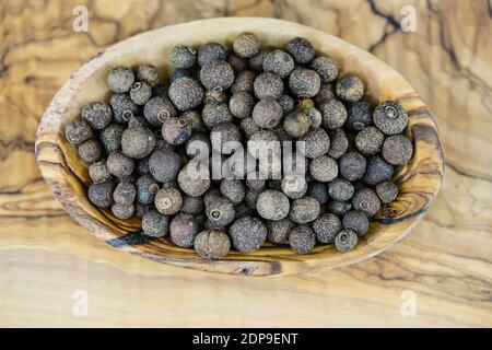 some allspice balls on olive wood Stock Photo - Alamy