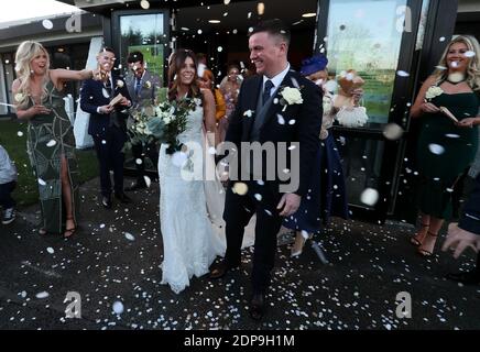 Emma Jesson and her new husband Adam Jesson are greeted by a small ...