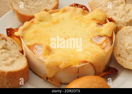 an oven-baked camembert with bread rolls Stock Photo - Alamy
