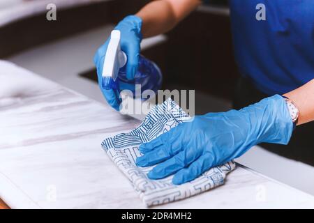 Cleaning home office table sanitizing kitchen table surface with ...