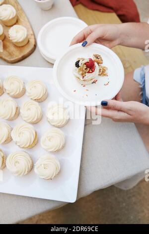 Female hands with tray of tasty muffins on wooden background Stock ...