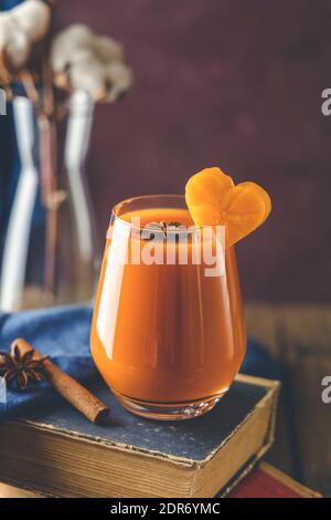 Persimmon fruit smoothie with cinnamon and anise stars, dark rusty ...