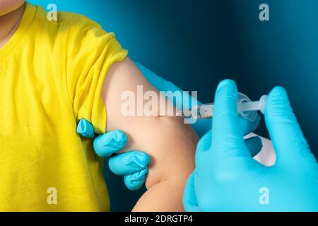 BCG vaccine scar. Scar on the arm of a 13-year-old boy following ...