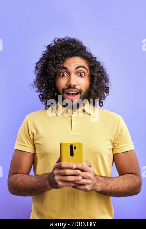 Man with smartphone being surprised as reading message Stock Photo - Alamy