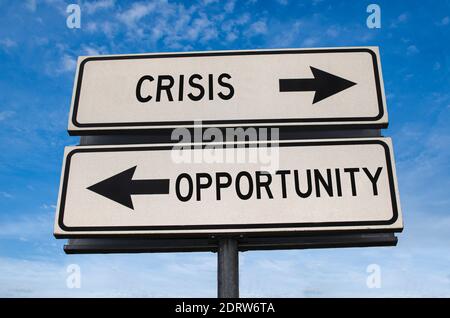 CRISIS versus OPPORTUNITY directional signs Stock Photo - Alamy