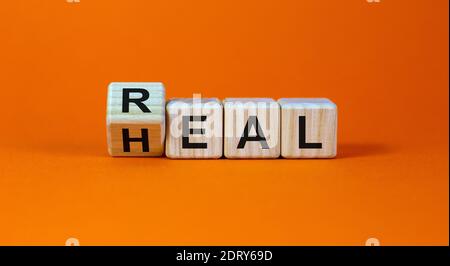 Fliped a wooden cube with words 'Real heal'. Medical and real heal ...