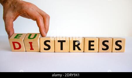 Distress or eustress. Male hand turns cubes and changes the word ...