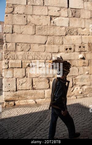 Traditional Turkish Simit seller walking past Antique carpet shops in ...