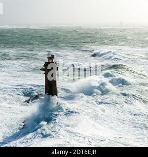 'La Jument' lighthouse during heavy storm off Ouessant Island in ...