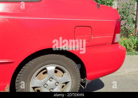 Metal corrosion on a car fender, rust hole. car body repair. Front view ...