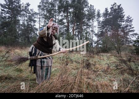 Baba Yaga in a mortar and with a broom, female actor Stock Photo - Alamy