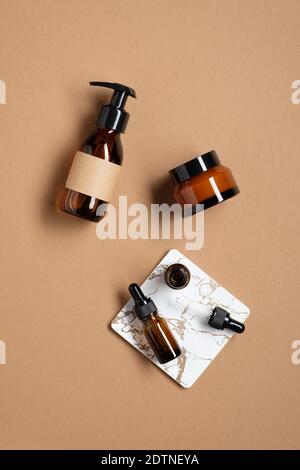 Blank amber glass face serum bottle on turquoise background. Abstract ...