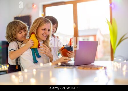Busy mother working from home with little daughter Stock Photo - Alamy