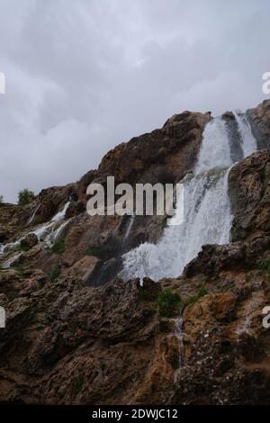 Beautiful hidden waterfall falling over multiple levels. surrounded by ...