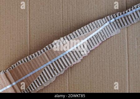 Pull to open strip at cardboard box Stock Photo - Alamy
