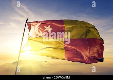official flag of Selangor Malaysia at cloudy sky background on sunset ...