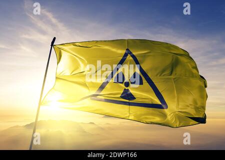 Radioactive flag waving on the top sunrise mist fog Stock Photo - Alamy