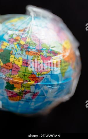 The planet earth is wrapped in plastic. Ecological disaster concept ...