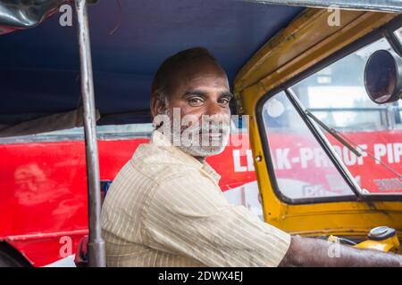 Portrait of a happy auto rickshaw driver looking back Stock Photo - Alamy