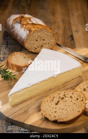 Brie cheese triangle with bread and parsley Stock Photo - Alamy