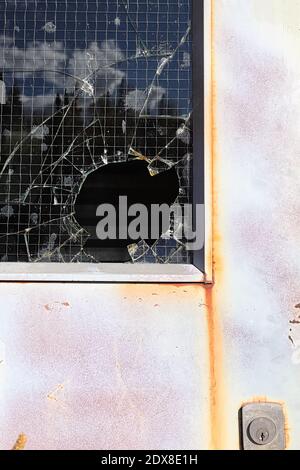 Window safety glass, wired glass, smashed, fragmented, with holes. At ...
