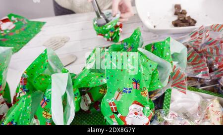 Step by step. Packaging homemade fudge and cookies into a Christmas ...