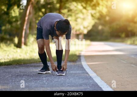 Asian Runner man running in city park morning outdoors Stock Photo - Alamy