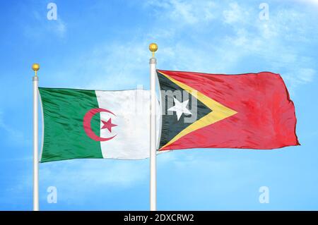 Algeria and East Timor flag waving in the wind against white cloudy ...