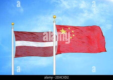 Latvia and China flag waving in the wind against white cloudy blue sky ...