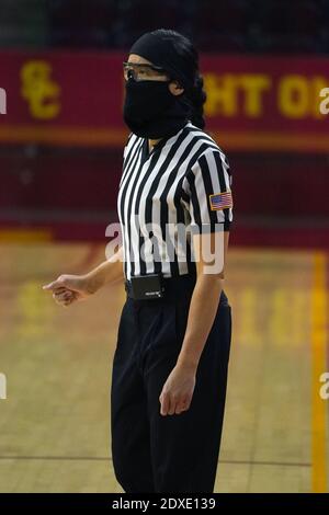 Referee Kaili Kimura wears a face mask and glasses during an NCAA ...