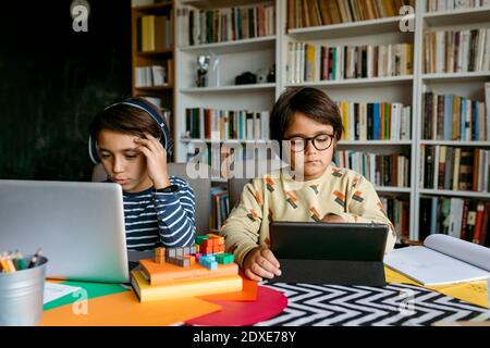 student boy with tablet computer learning at home Stock Photo - Alamy