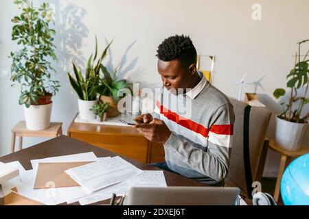 Financial advisor on phone at desk, analyzing spreadsheets on computer ...