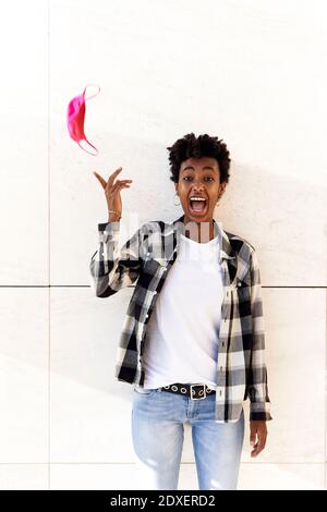 Black and white portrait of woman throwing cloth in the air. Isolated ...