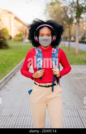 Young woman wearing student backpack and holding books screaming proud ...