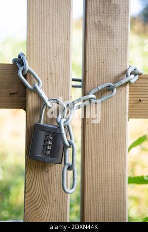 Gates padlocked up with a heavy duty padlock at the entrance to a field ...