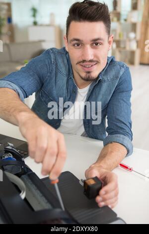 man fixing a printing machine Stock Photo - Alamy