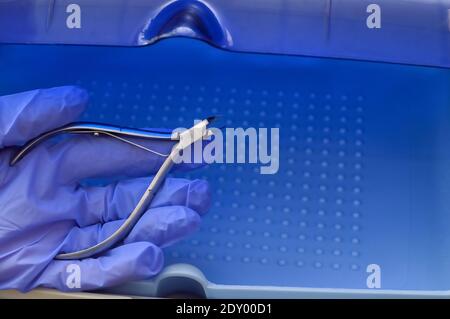 Hand with manicure and pedicure forceps after sterilization and ...