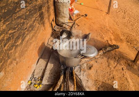 African outdoors kitchen firewood, big cast pots boiling in a village ...