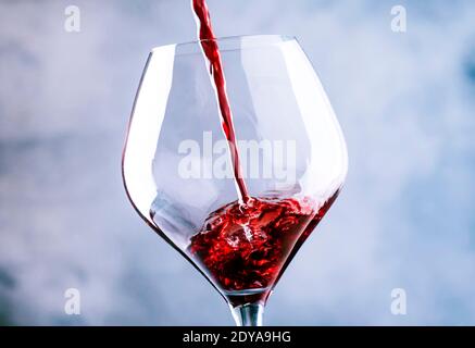 French dry red wine, pours into glass, gray background, banner ...