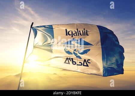 flag of Iqaluit, Nunavut , Canada at cloudy sky background on sunset ...