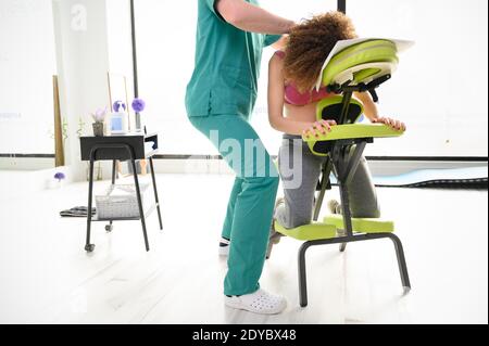 Physiotherapist doing massage to pregnant woman in spa center Stock ...