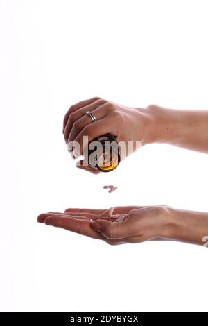 Falling medicine pills and antibiotics isolated over pink background ...