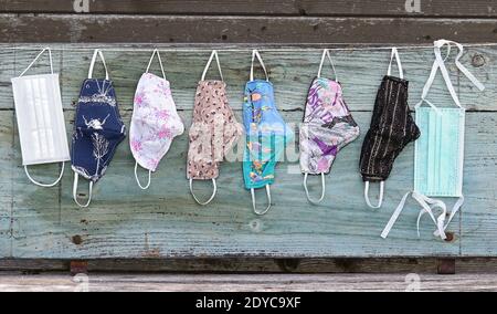 Various purchased and self-sewn protective masks, or makeshift masks ...