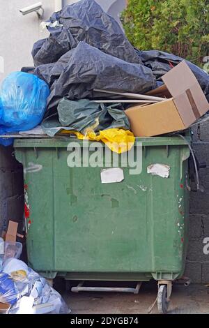 Overload dumpster container with garbage trash waste pile up Stock ...
