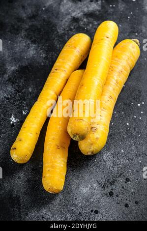 Yellow organic carrots without tops. Black background. Top view Stock ...
