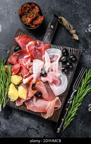 Sliced pork Jamon meat with rosemary Stock Photo - Alamy
