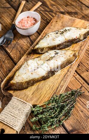 Baked halibut fish steak. wooden background. Top view. Copy space Stock ...